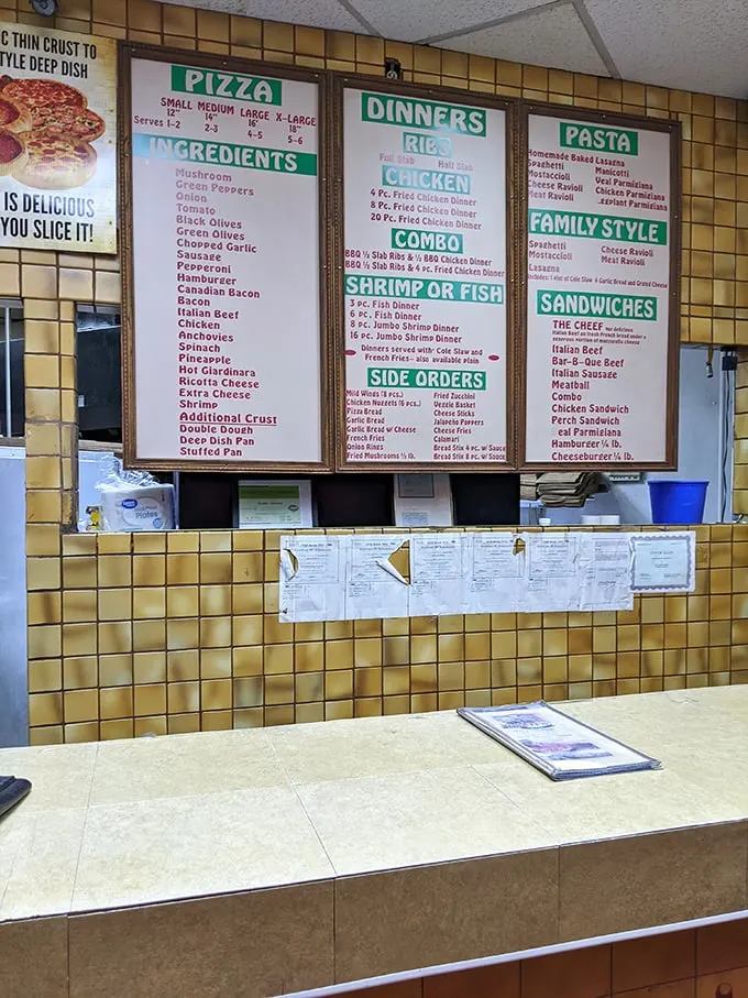 The menu wall—a yellow-tiled monument to possibility where indecision isn't a bug, it's a feature.