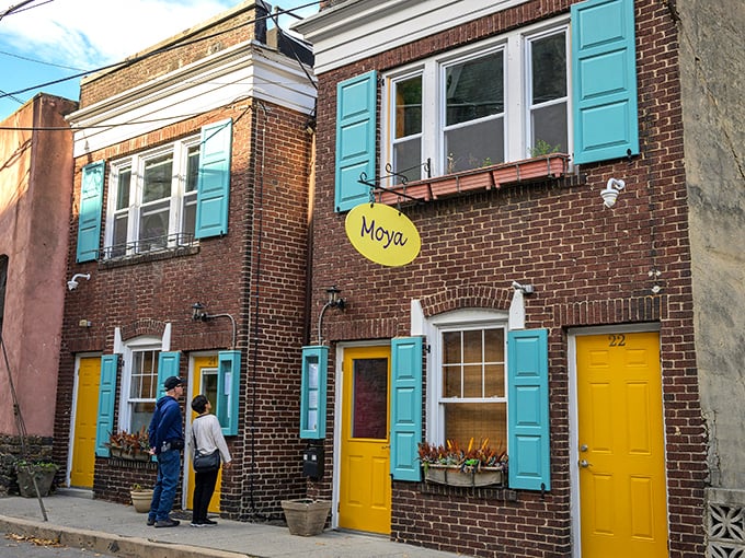 Moya's bright yellow door and turquoise shutters aren't just eye-catching—they're practically shouting "Come eat something delicious!" Like a Wes Anderson set that serves actual food.