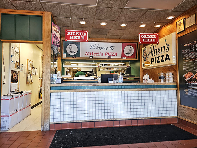 The quintessential pizza joint counter—where culinary dreams are ordered, magic happens behind the scenes, and happiness is picked up.