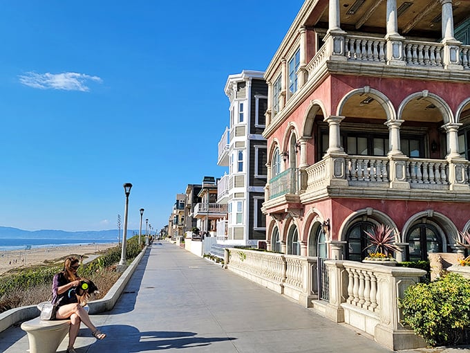That pink Mediterranean-style beauty isn't showing off—it's just living its best coastal life while making the rest of us reconsider our life choices.