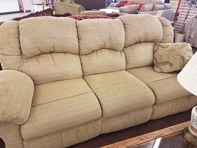This beige three-seater sofa isn't just comfortable—it's a conversation starter waiting to happen in your living room at a fraction of retail price.