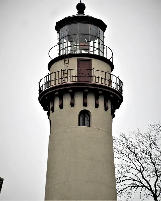 Looking up at the lighthouse's crown jewel—its distinctive lantern room where the historic Fresnel lens once guided countless ships to safety.