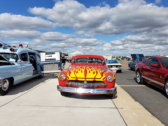 Classic cars with personalities as vibrant as their paint jobs share space with aviation history. That flame job would make Guy Fieri jealous!