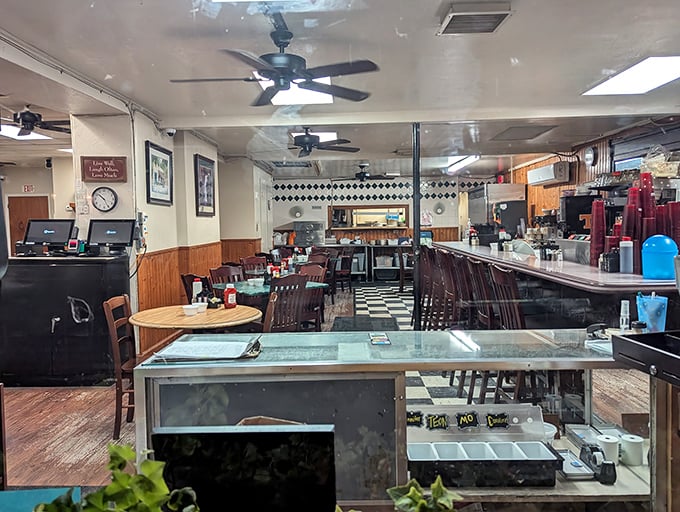 Classic diner charm at its finest – black and white checkered floors, wooden paneling, and ceiling fans that have witnessed countless Savannah mornings.