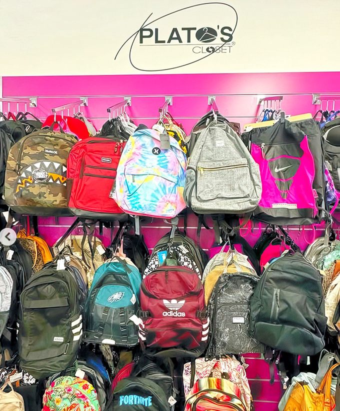 A kaleidoscope of backpacks hangs like fashionable fruit, from tie-dye dreams to Eagles pride, ready for their second adventure.