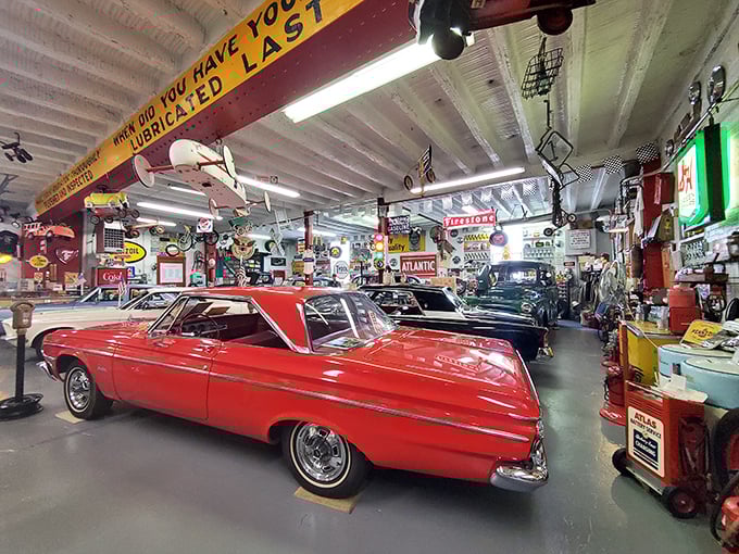 The fiery red convertible commands attention amid a sea of vintage signs. If cars could talk, this one would definitely be the loudest at the party.