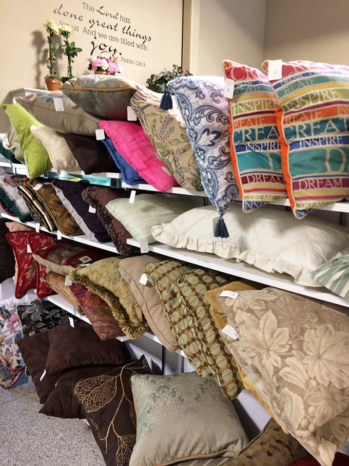 A kaleidoscope of decorative pillows awaits new homes—each one telling a different story and ready to transform someone's couch from drab to fab.