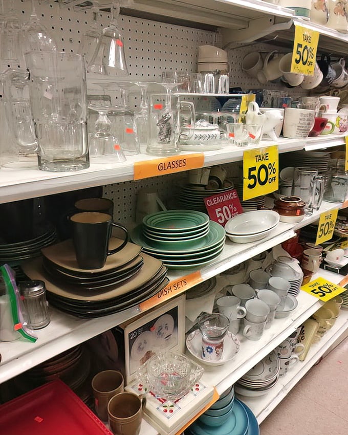 Dinnerware paradise where mismatched becomes a design choice. Those 50% off signs are the siren song of thrift store enthusiasts.