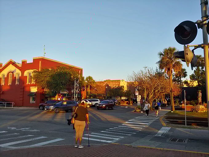 Golden hour bathes downtown Fernandina Beach in warm light, turning an ordinary crosswalk into the threshold between everyday life and small-town magic.
