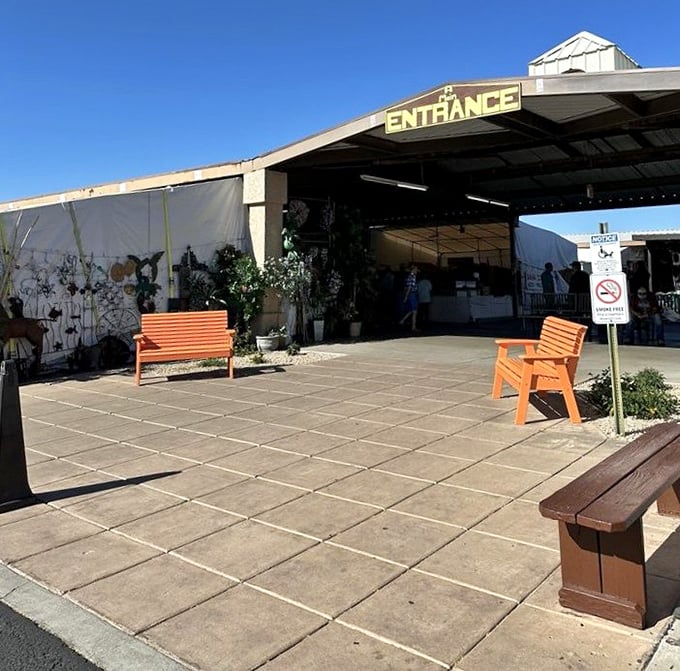 The entrance beckons with its cheerful orange benches – nature's way of saying "rest here after you've shopped yourself silly."