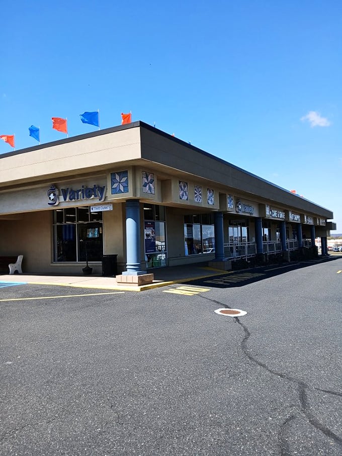 The unassuming exterior belies the treasure trove within. Those colorful flags aren't just decoration—they're waving you in for an adventure in secondhand paradise.