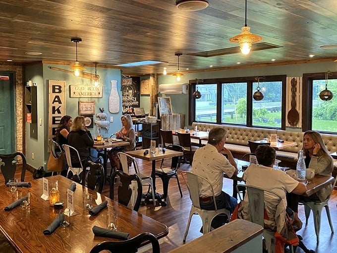 Wooden ceilings, vintage signs, and conversation-friendly tables create that rare atmosphere where time slows down and appetites wake up.