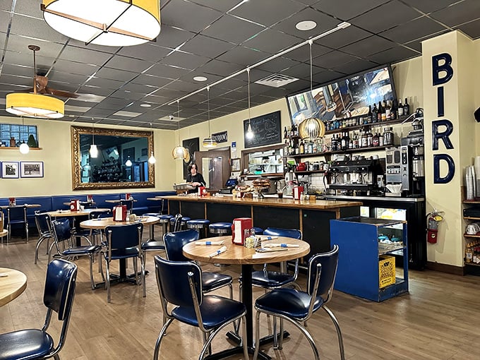 Classic diner aesthetics meet modern comfort inside, where those blue chairs aren't just seating—they're front-row tickets to breakfast theater.