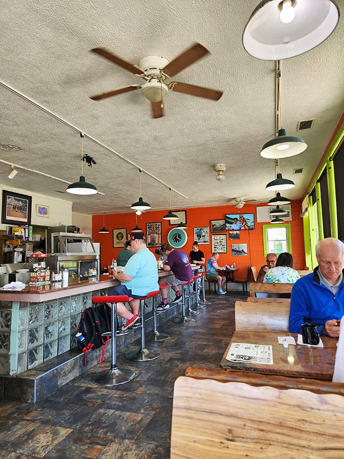 Classic counter seating, orange walls, and ceiling fans spinning stories—this isn't retro by design, it's authentic by survival.