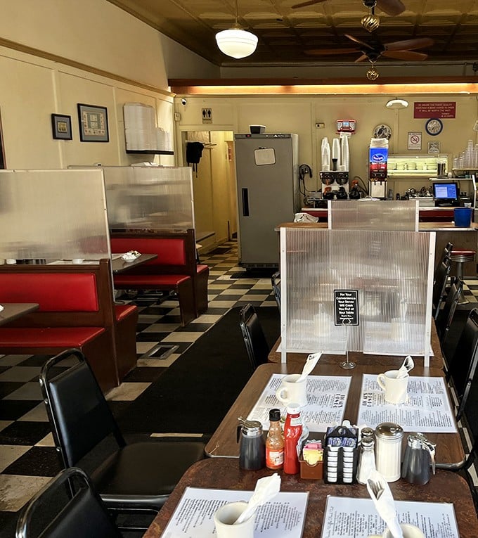 Classic diner perfection with checkerboard floors and red vinyl booths. This isn't retro by design—it's authentic by survival.