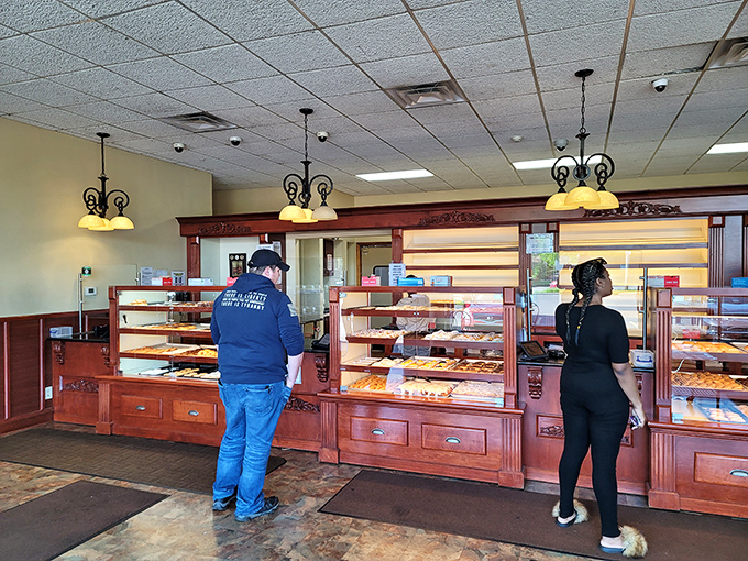No-nonsense display cases and warm wood tones tell you immediately: this place prioritizes substance over style. The pastries do the talking.