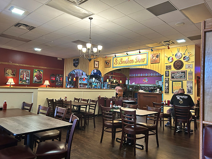 Yellow walls adorned with memorabilia create the perfect backdrop for breakfast epiphanies. The chandelier adds unexpected elegance, like wearing pearls with pajamas.