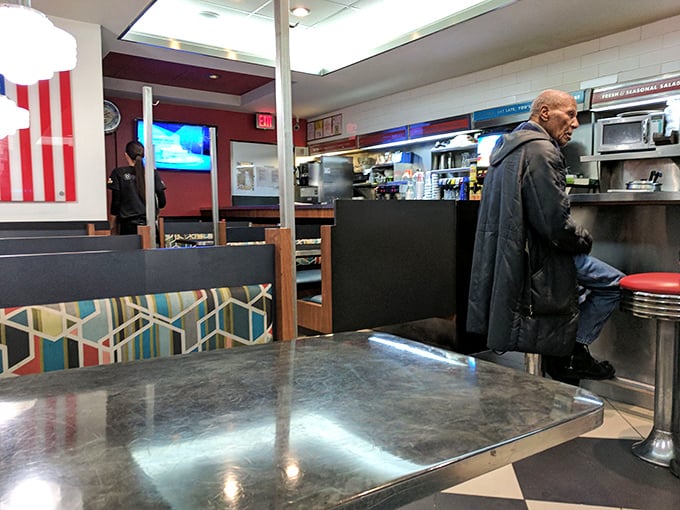 Inside, the quintessential diner experience awaits – counter seating, cozy booths, and the promise of conversations with strangers who might become friends.