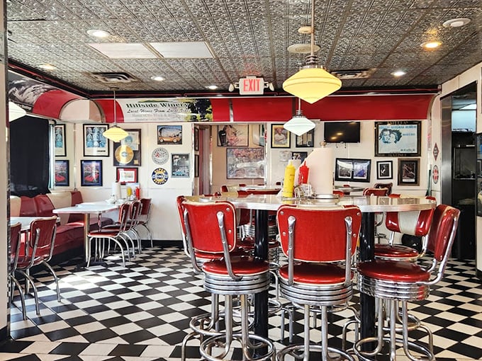 Red vinyl stools and checkerboard floors transport you straight to the 1950s. This isn't decoration—it's a portal to simpler times.
