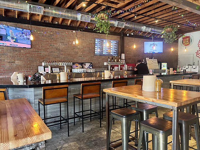 Industrial chic meets barbecue comfort – exposed brick, wooden tables, and hanging plants create the perfect backdrop for meat-induced euphoria.