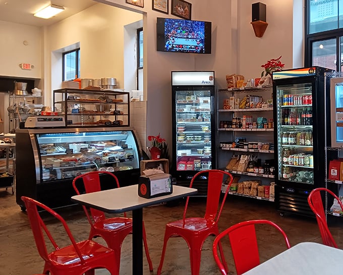 Red metal chairs pop against industrial simplicity – this isn't just a sandwich shop, it's a neighborhood gathering spot where food dreams come true.