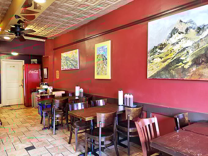 Red walls adorned with local art create a warm, unpretentious atmosphere where the focus remains squarely on what matters most—the food.