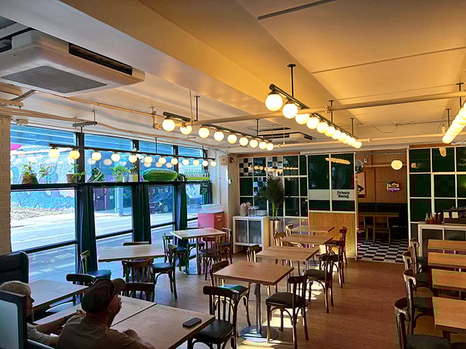 Sunlight streams through large windows, illuminating wooden tables and checkered floors—the perfect stage for sandwich artistry to unfold.
