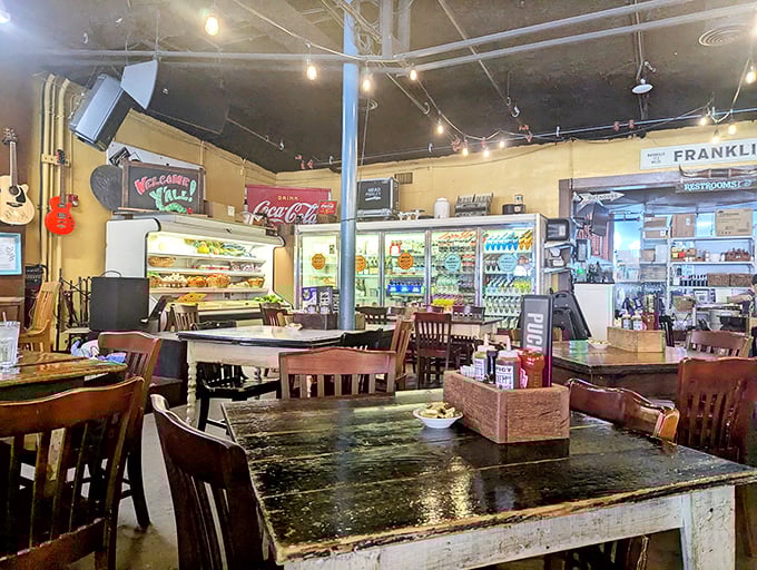 Step inside and time slows down – wooden tables bearing the patina of countless meals, vintage signs, and refrigerator cases that whisper of Puckett's grocery store origins.