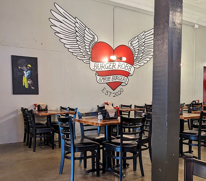 That winged heart logo isn't just decoration—it's a warning that these burgers might actually make your heart take flight. The simple interior lets the food do the talking.