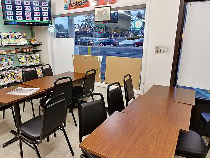 Simple tables, basic chairs, and a lottery board – because the real jackpot here is what comes from the kitchen.