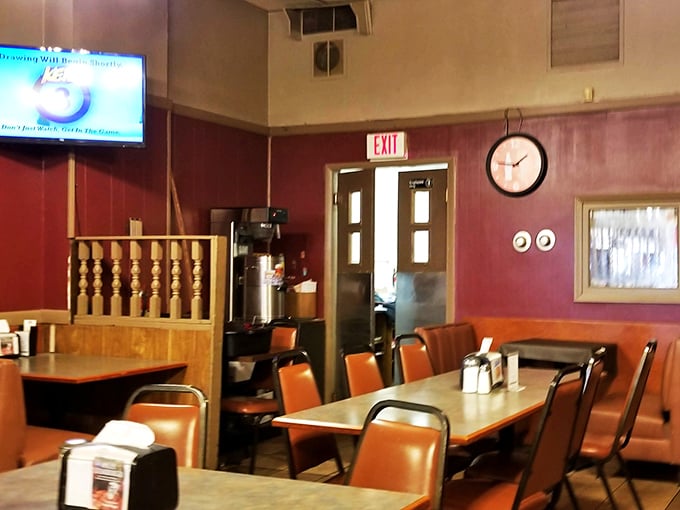 Classic burgundy walls and orange vinyl booths create the perfect time capsule where conversations flow as freely as the coffee refills.
