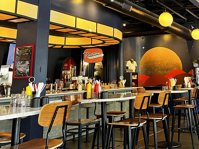 Inside, a cosmic collision of mid-century design and modern flair. That orange planetary backdrop isn't just décor—it's a promise of orbit-shifting flavors.