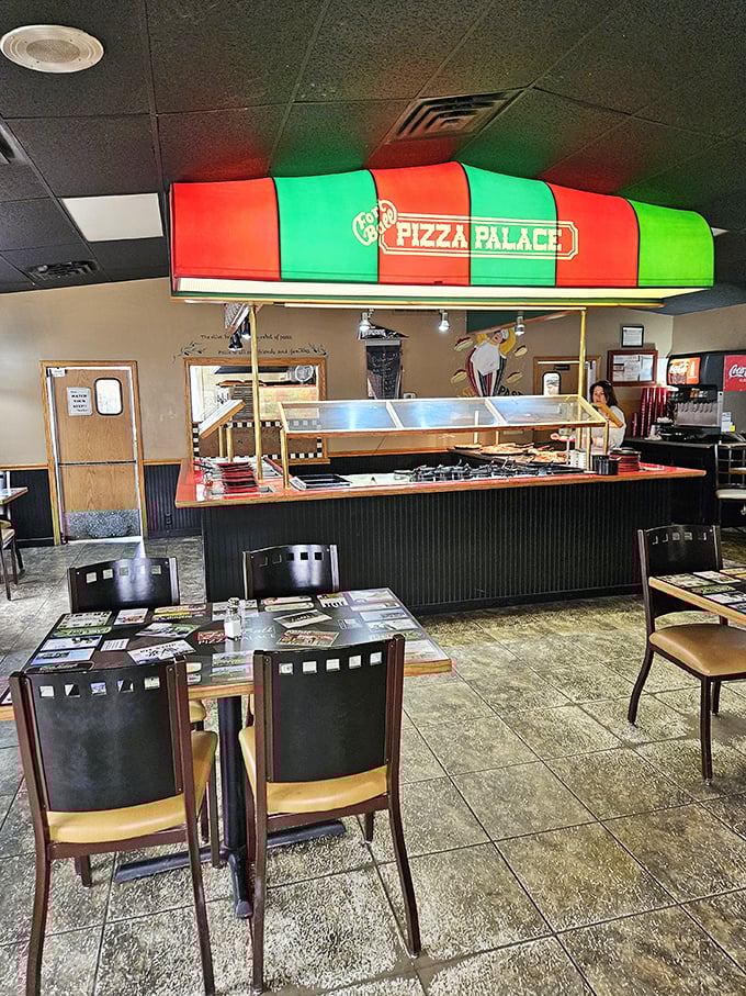 Under the iconic red and green striped awning, pizza magic happens daily. This buffet station is where dreams and cheese unite.