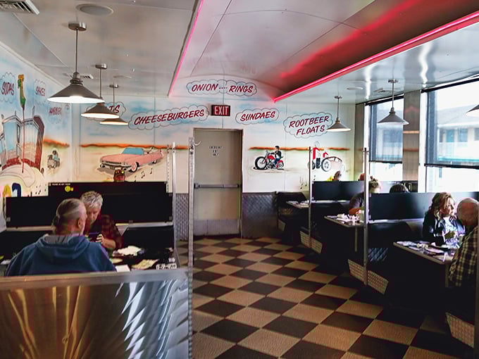 Step inside and you're transported to the golden age of diners—checkered floors, vintage murals, and hanging signs announcing life's simple pleasures: "CHEESEBURGERS" and "ROOTBEER FLOATS."