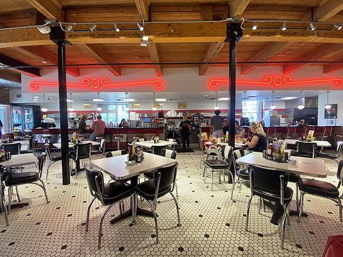 Classic chrome tables, black vinyl chairs, and that hexagonal tile floor—this isn't retro by design, it's authentic by survival.