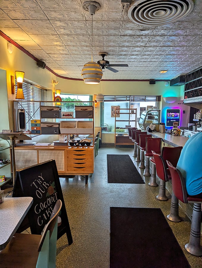 Where nostalgia meets comfort. The pressed tin ceiling, vintage pendant lights, and classic counter stools create a diner experience straight from the American dream playbook.