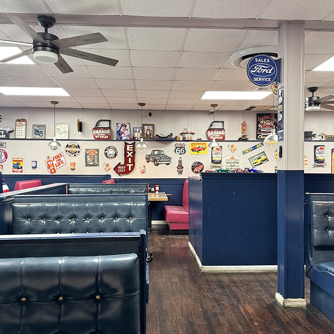Vintage automotive memorabilia transforms dining into time travel. Those blue booths have witnessed countless "best burger ever" declarations. 