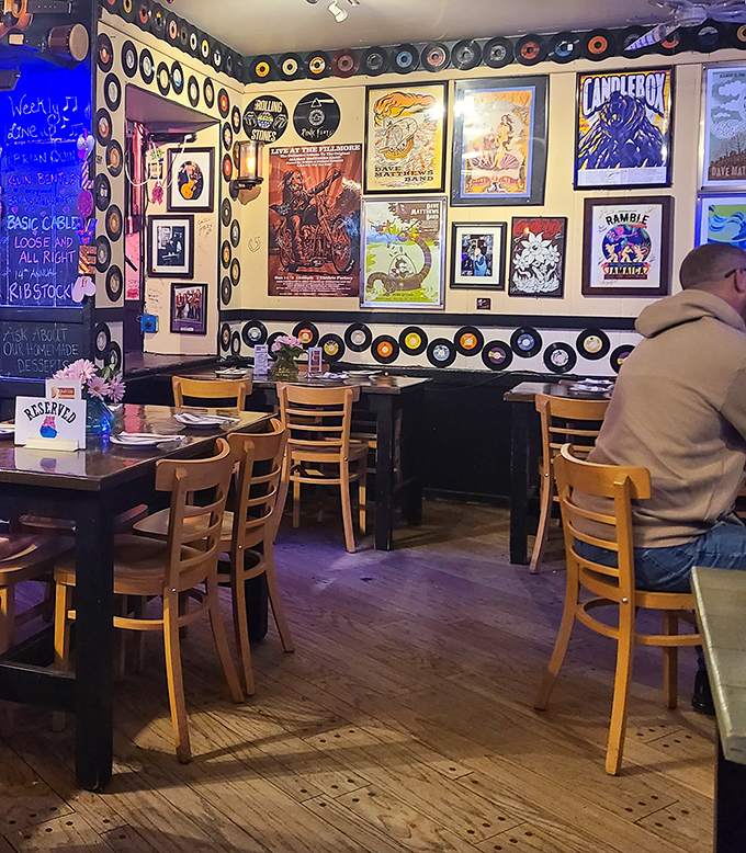 Vinyl records line the walls like a musical timeline, creating an atmosphere where classic rock meets classic BBQ in perfect harmony.