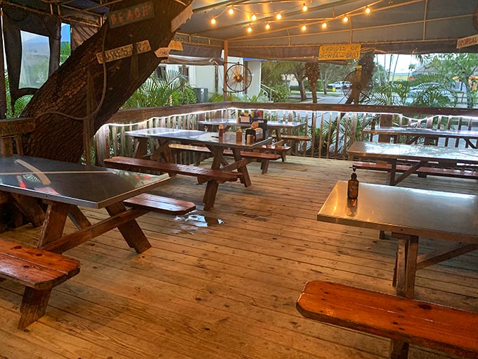 Picnic tables under string lights create that "I've discovered something special" atmosphere—part beach shack, part hidden gem, all charm.