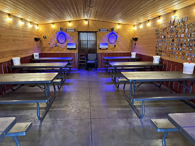 Inside, the wood-paneled dining area offers respite from the elements, with blue lighting adding an unexpected touch of ambiance to this temple of smoked meats.