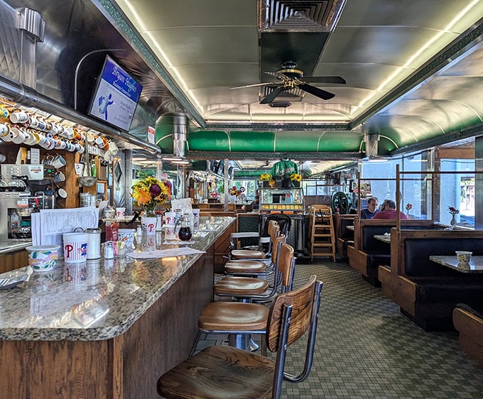 This railroad car interior is what diner dreams are made of – green trim and all.