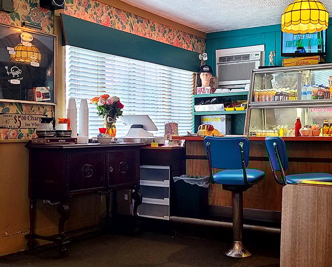 Blue swivel counter stools and vintage floral wallpaper – stepping into Fred's is like finding a time machine that happens to serve exceptional coffee.