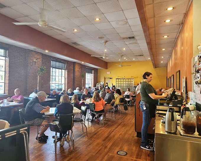 Inside, warm yellow walls and exposed brick create the perfect backdrop for Durham's morning ritual of coffee and conversation.
