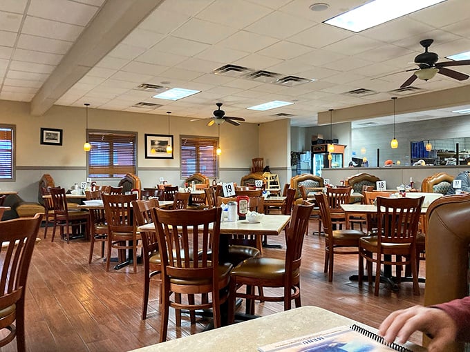 Inside, wooden chairs and warm lighting create that perfect diner atmosphere—where conversations flow as freely as the coffee refills.