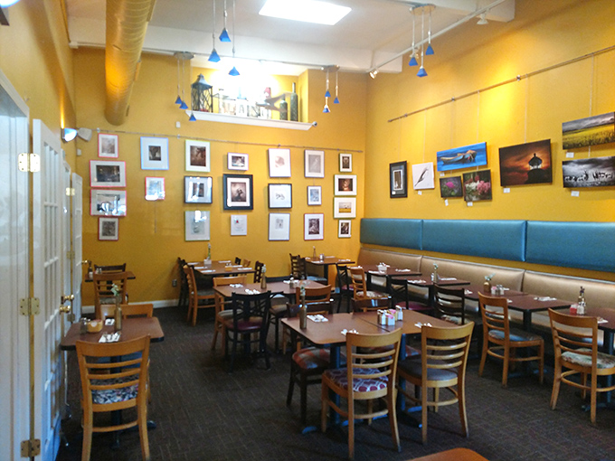 Sunshine-yellow walls adorned with local artwork create the perfect backdrop for morning conversations and coffee refills.