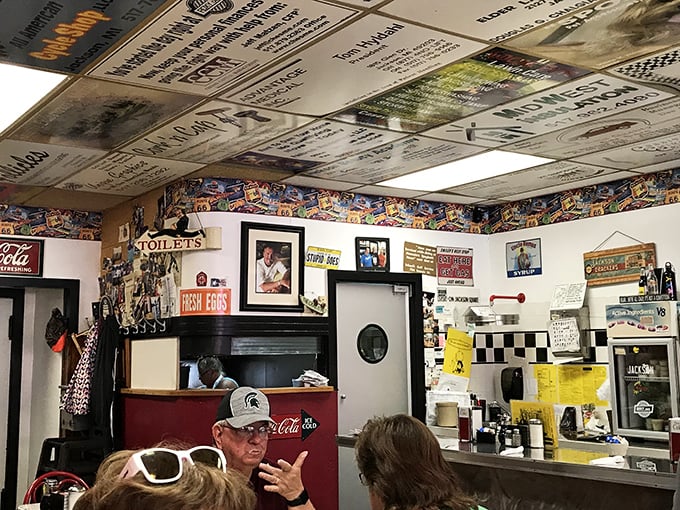 Step inside and the ceiling tells stories – literally. Years of signatures and mementos create a living guestbook above diners' heads.