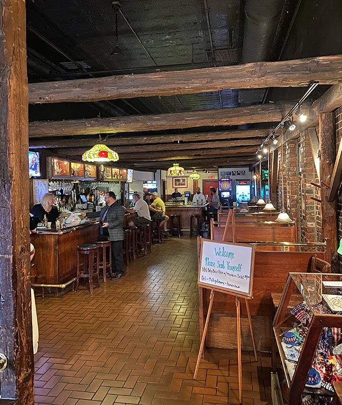 Step inside and time slows down – exposed wooden beams and brick walls tell stories of countless gatherings while Tiffany-style lamps cast a warm glow.