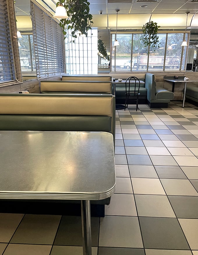Mint-green booths and checkerboard floors—this isn't just retro design, it's a portal to when conversations happened face-to-face and phones were attached to walls.