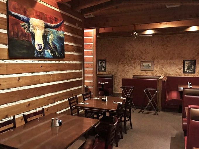 Rustic log cabin walls meet cozy booths while a colorful longhorn keeps watch. It's like dining in a Western movie, but with better food.