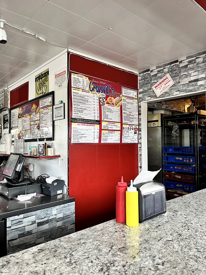 Behind every great drive-in is an ordering counter that's seen it all. The classic red and white color scheme isn't just decoration—it's a promise of Americana on a plate.